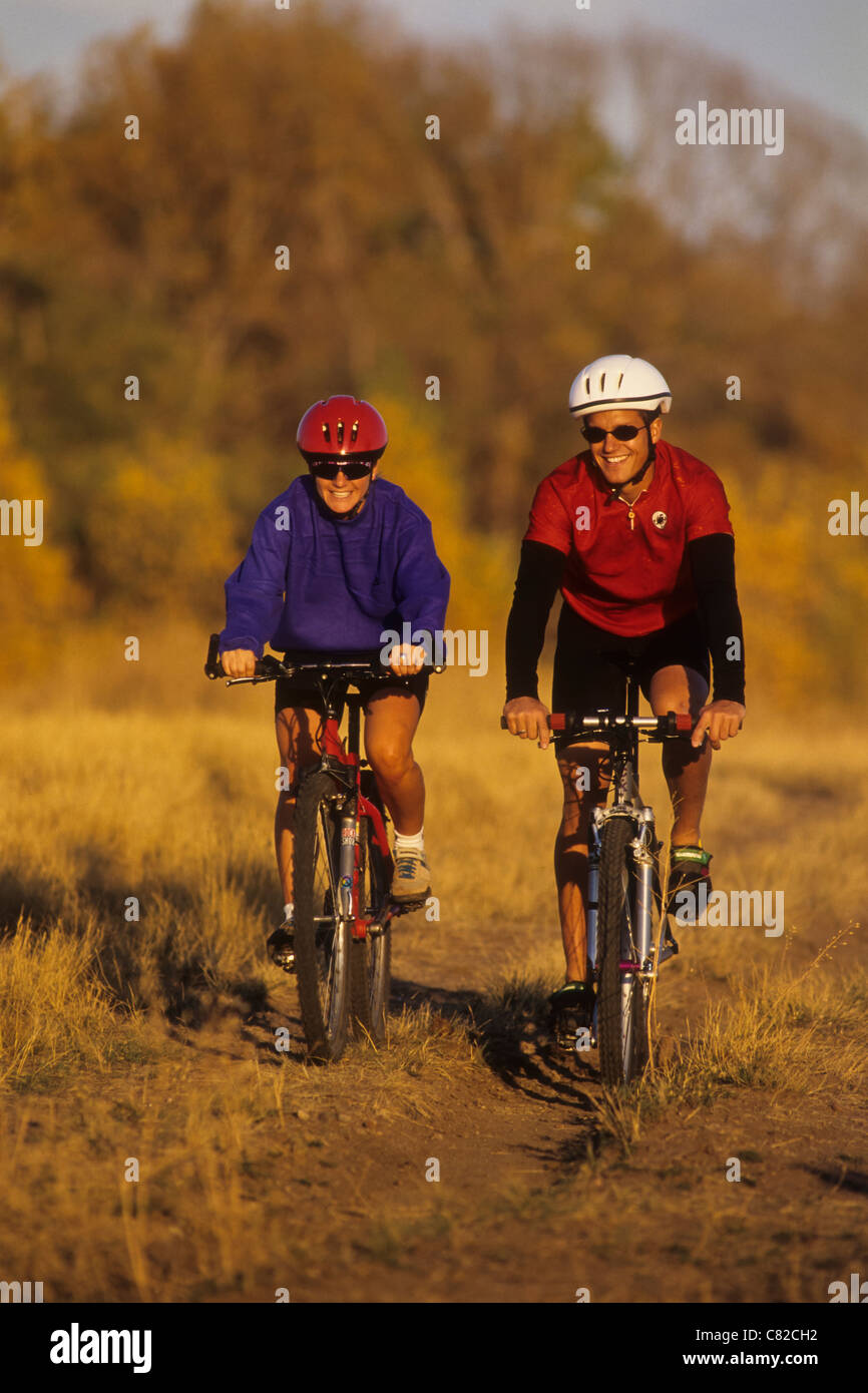 Couple mountain biking in Fall Stock Photo - Alamy