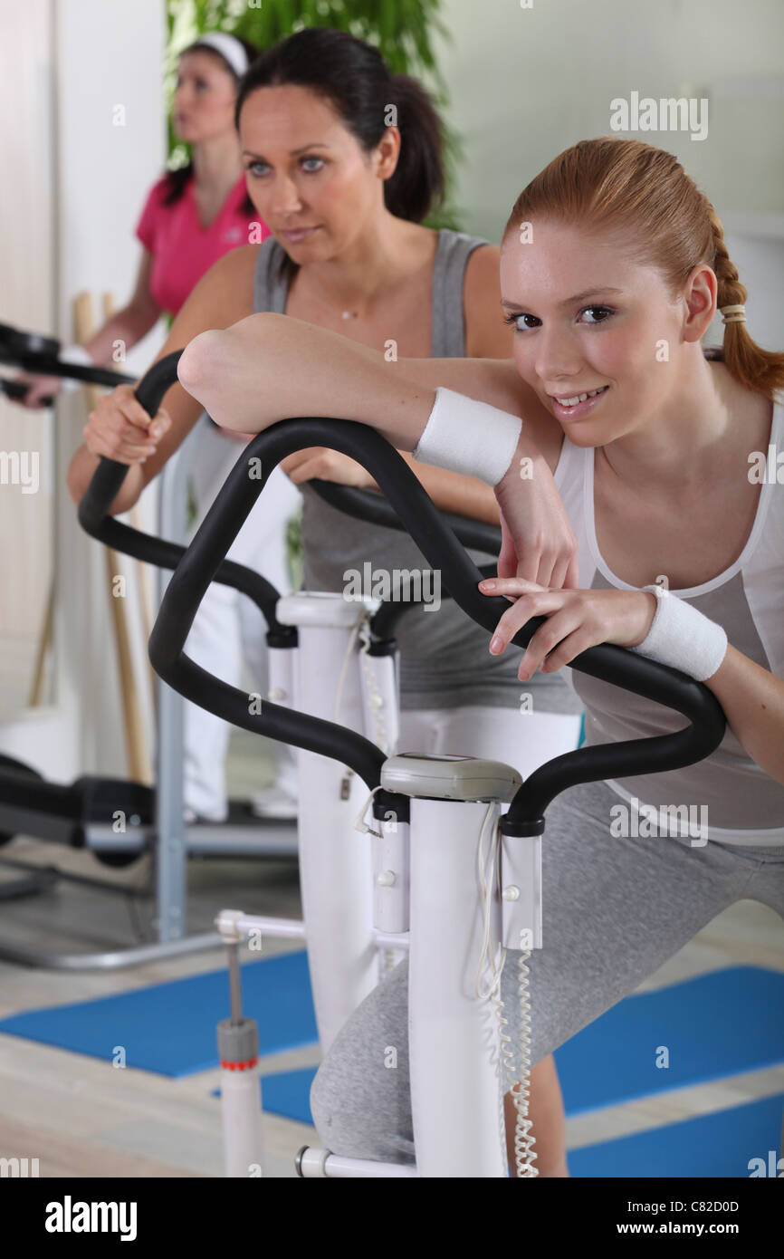 Young women using exercise equipment Stock Photo - Alamy
