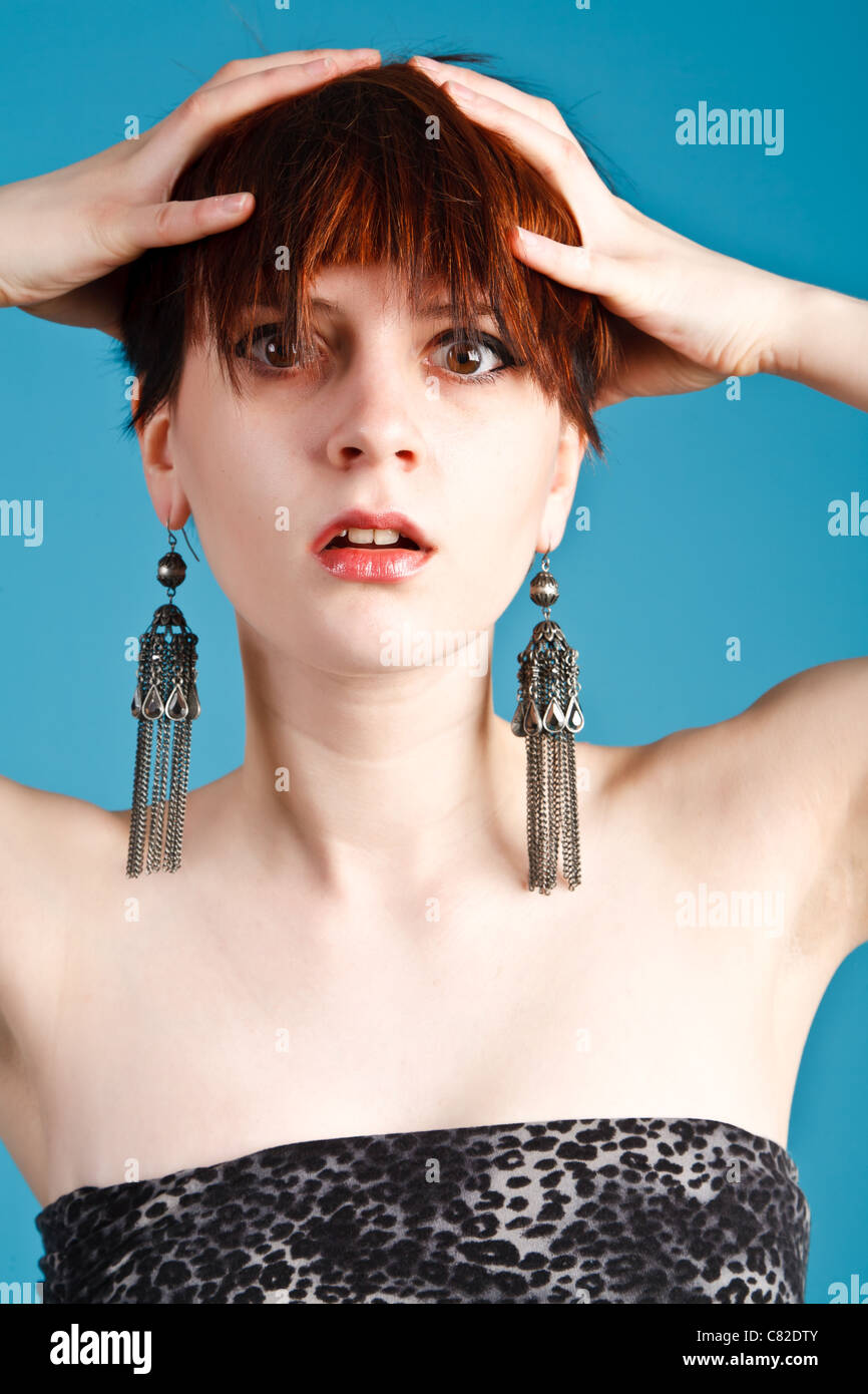 Stressed woman on the blue background Stock Photo - Alamy