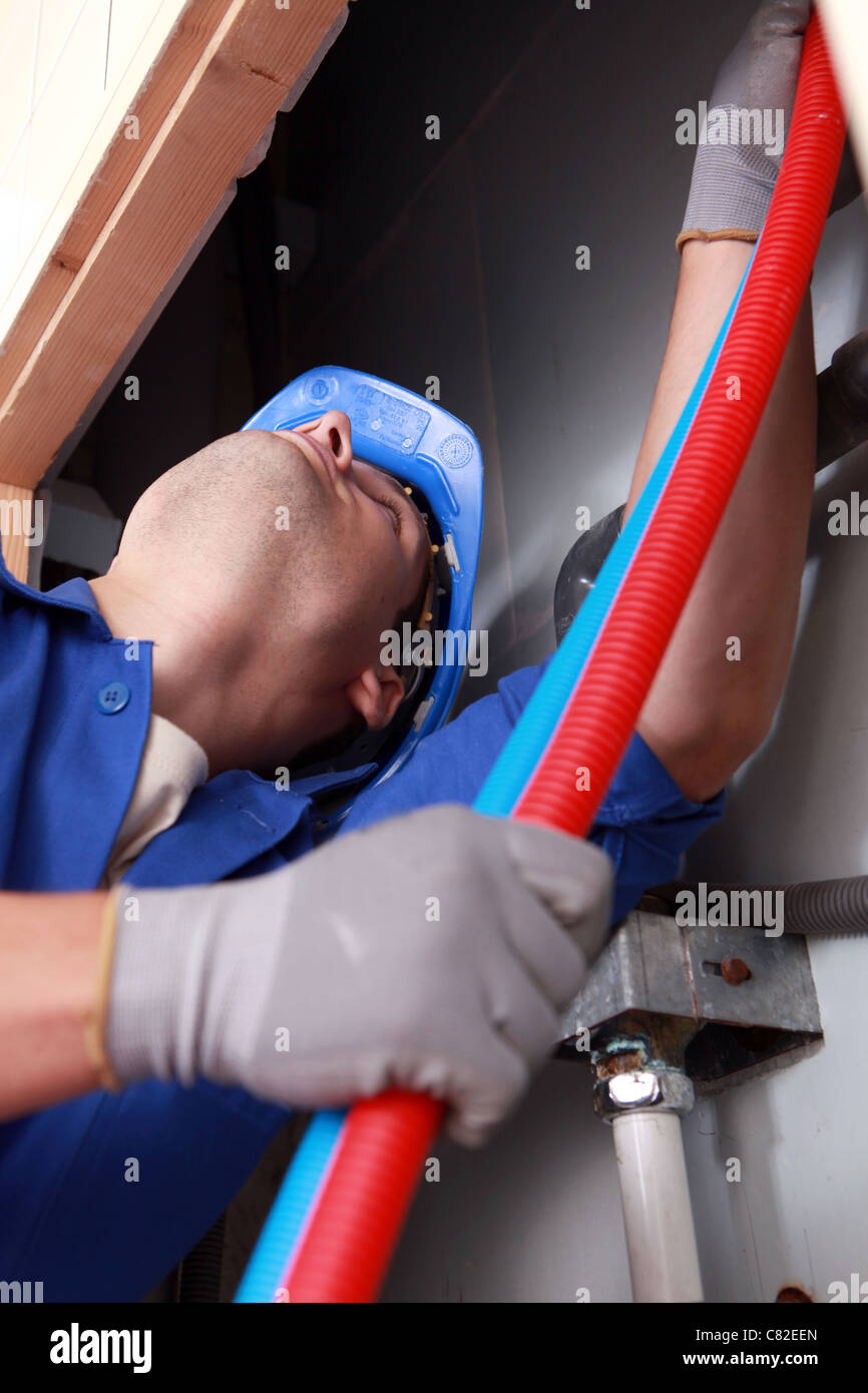 Plumber installing plastic domestic water pipes Stock Photo - Alamy