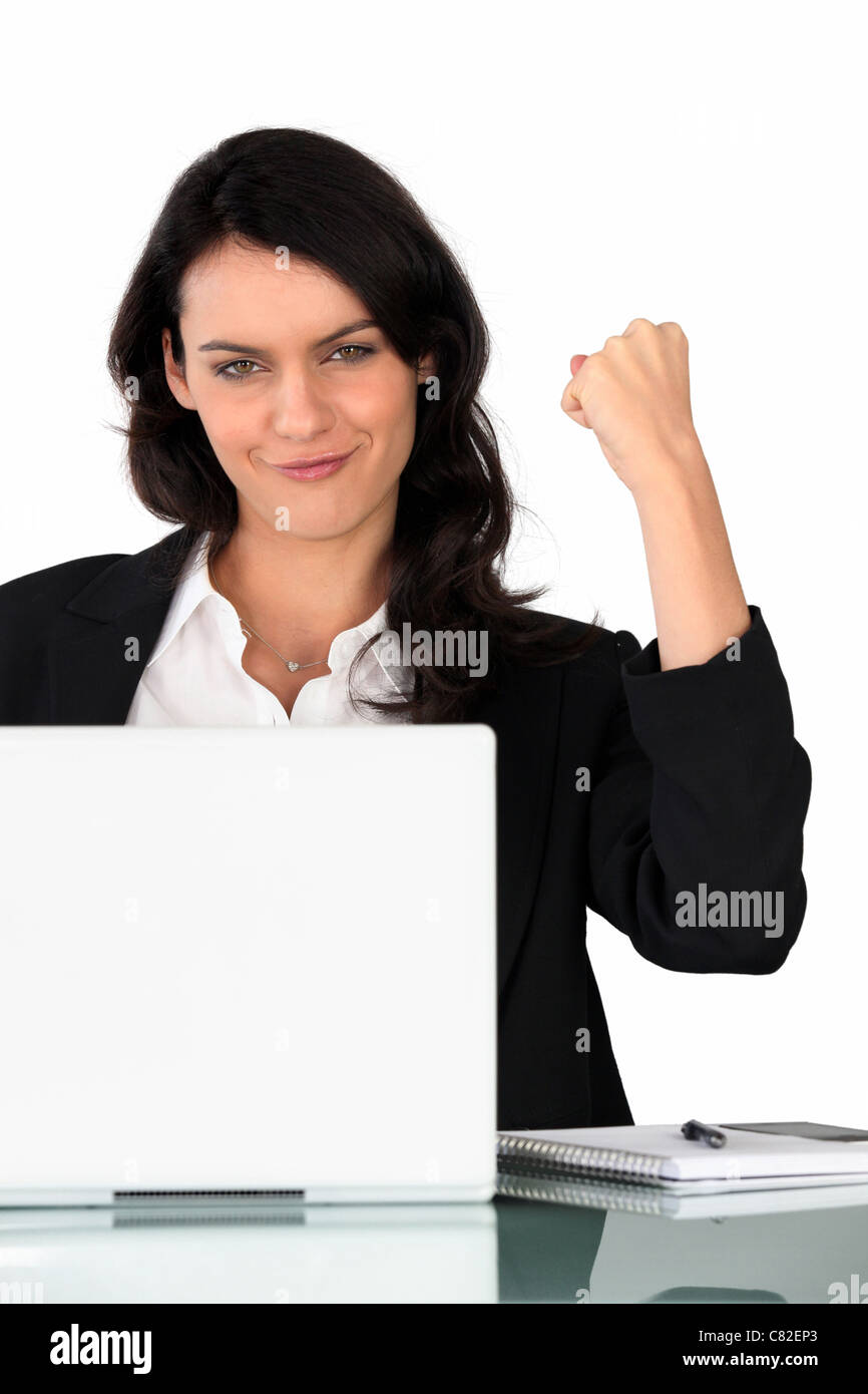 Businesswoman holding a triumphant fist in the air Stock Photo - Alamy
