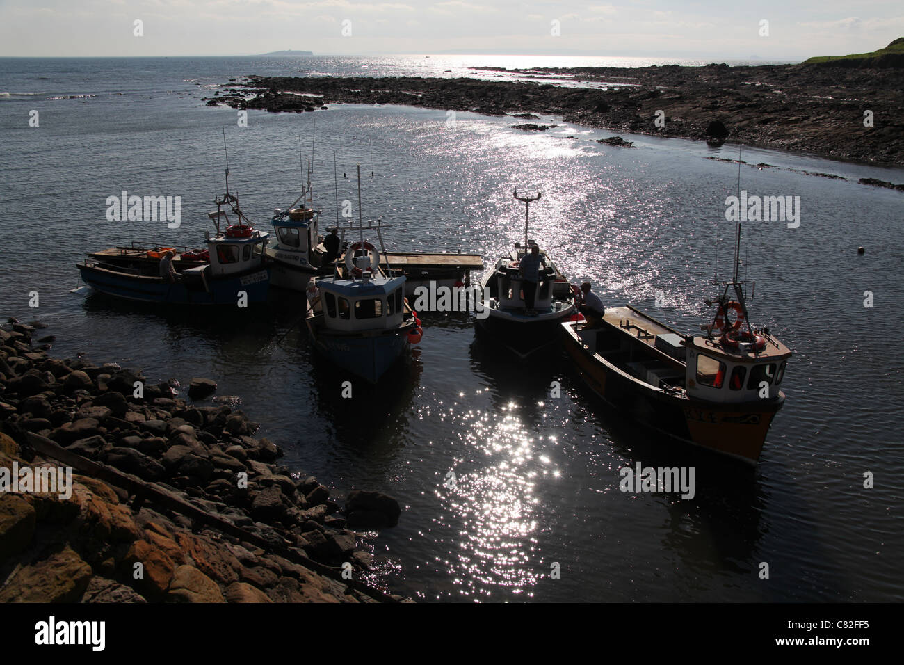 Town of Crail, Scotland. Silhouetted view of fishing boats waiting for ...
