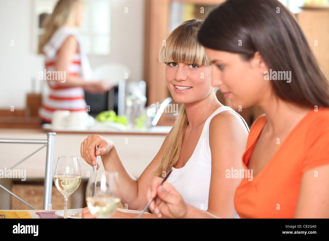 Girlfriends having lunch at home Stock Photo - Alamy