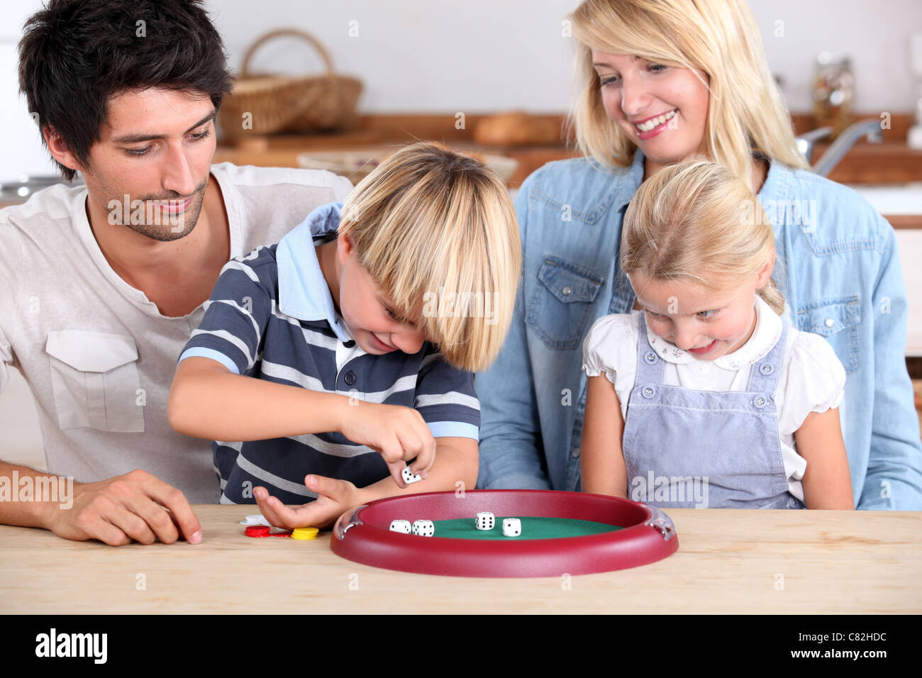 Family playing a dice game Stock Photo - Alamy