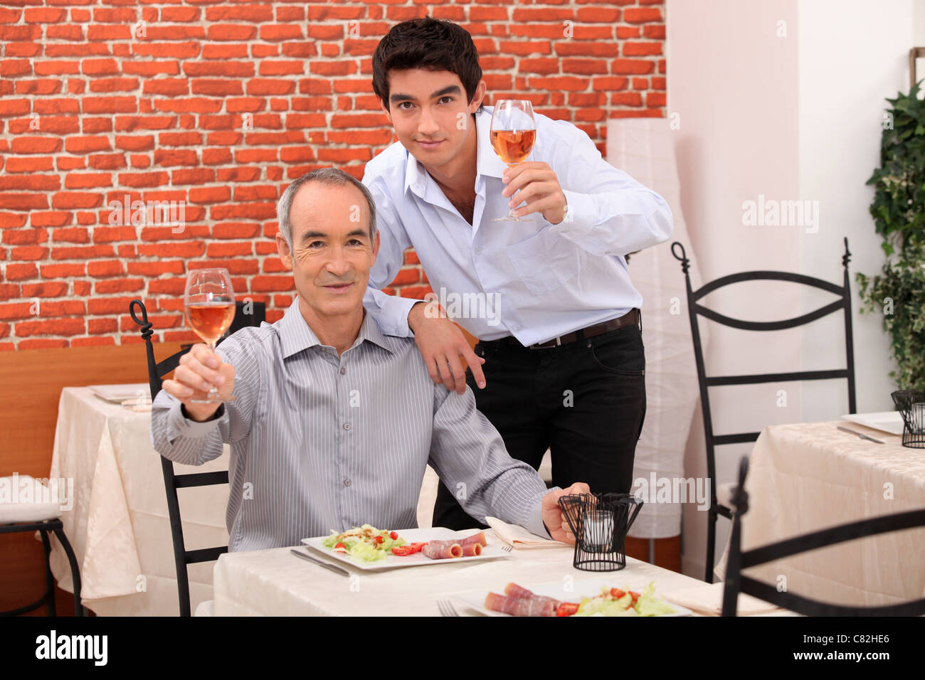Father and son having dinner together Stock Photo - Alamy