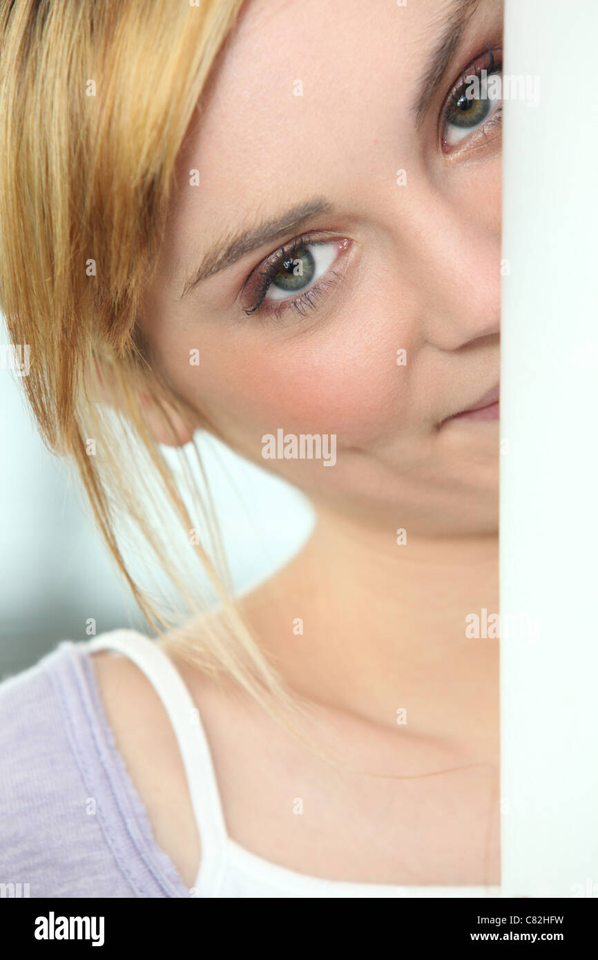 Blond woman with mischievous gaze Stock Photo - Alamy