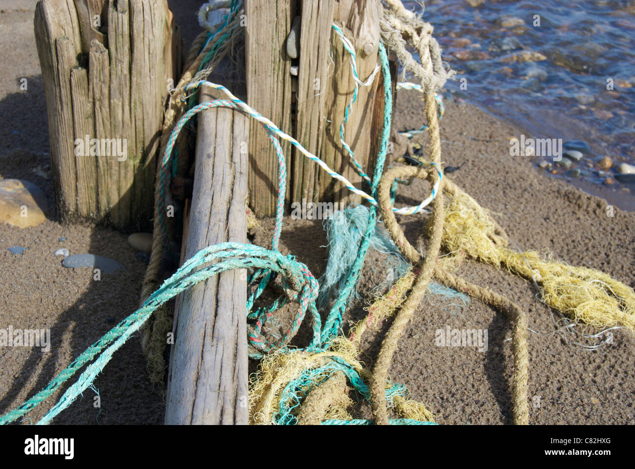 wood and rope stranded on a beach on the Yorkshire coast Stock Photo ...