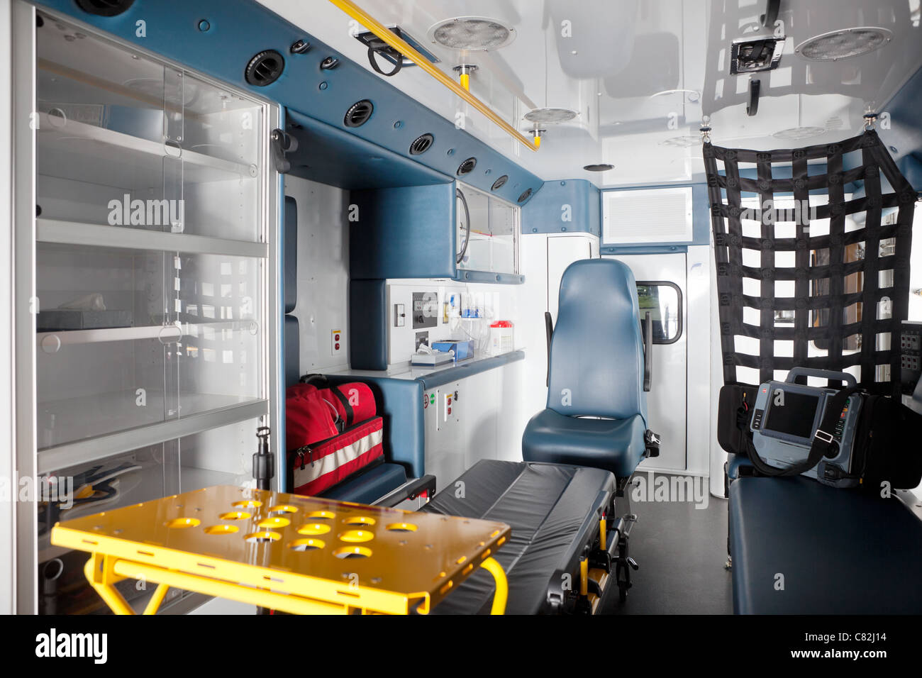 Empty ambulance interior with equipment on bench Stock Photo - Alamy
