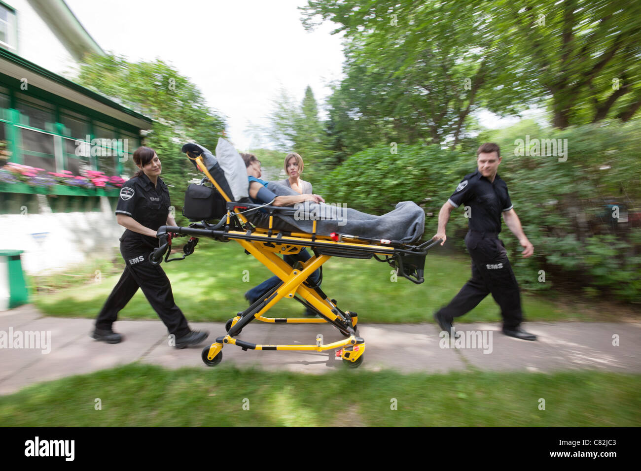 Senior woman being rush to hospital by ambulance staff Stock Photo - Alamy