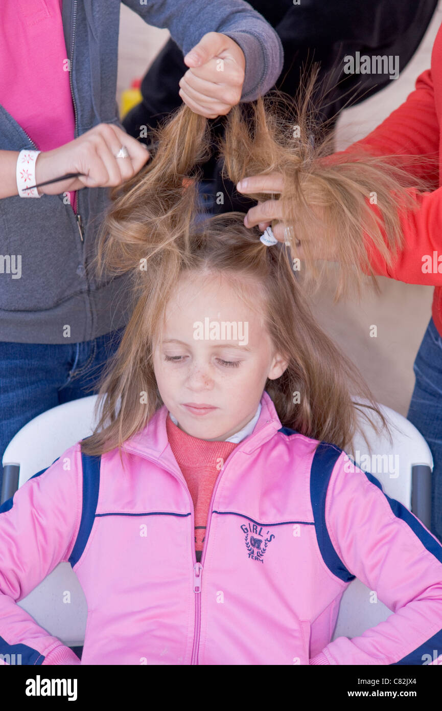 A young girl gets a freaky hairdo at the Crazy Hair Salon, Art Block ...