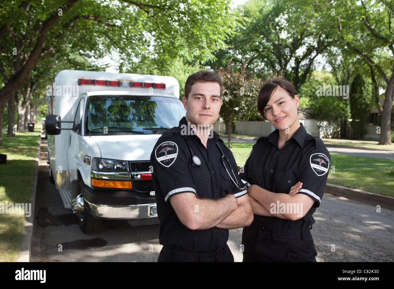Portrait of two paramedics standing in front of ambulance vehicle Stock ...