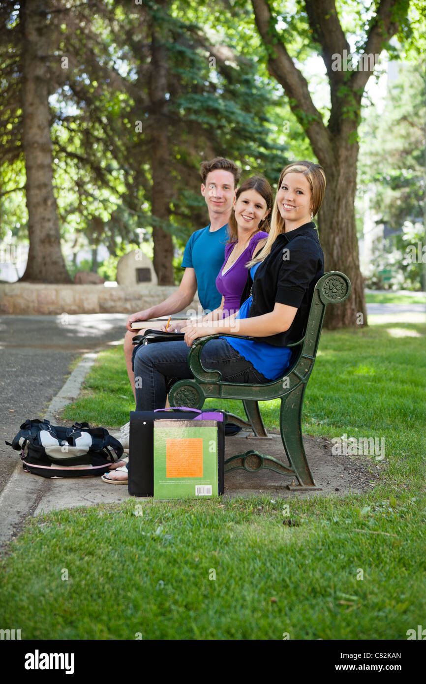 Portrait of students sitting on university campus bench Stock Photo - Alamy