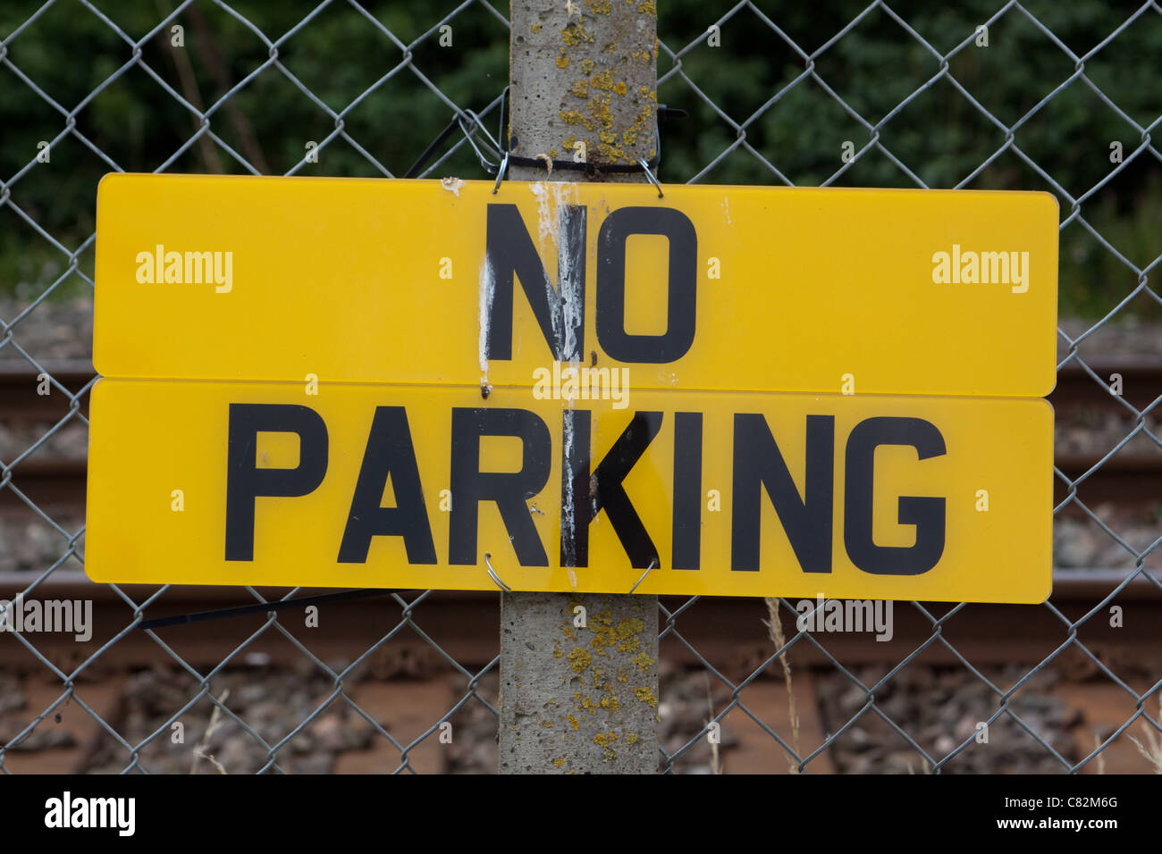 No Parking sign attached to a fence post Stock Photo - Alamy