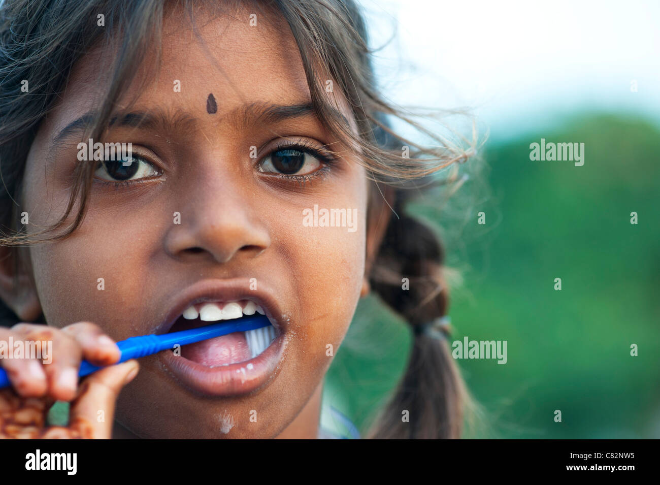 Happy young rural Indian village girl brushing her teeth. Andhra ...