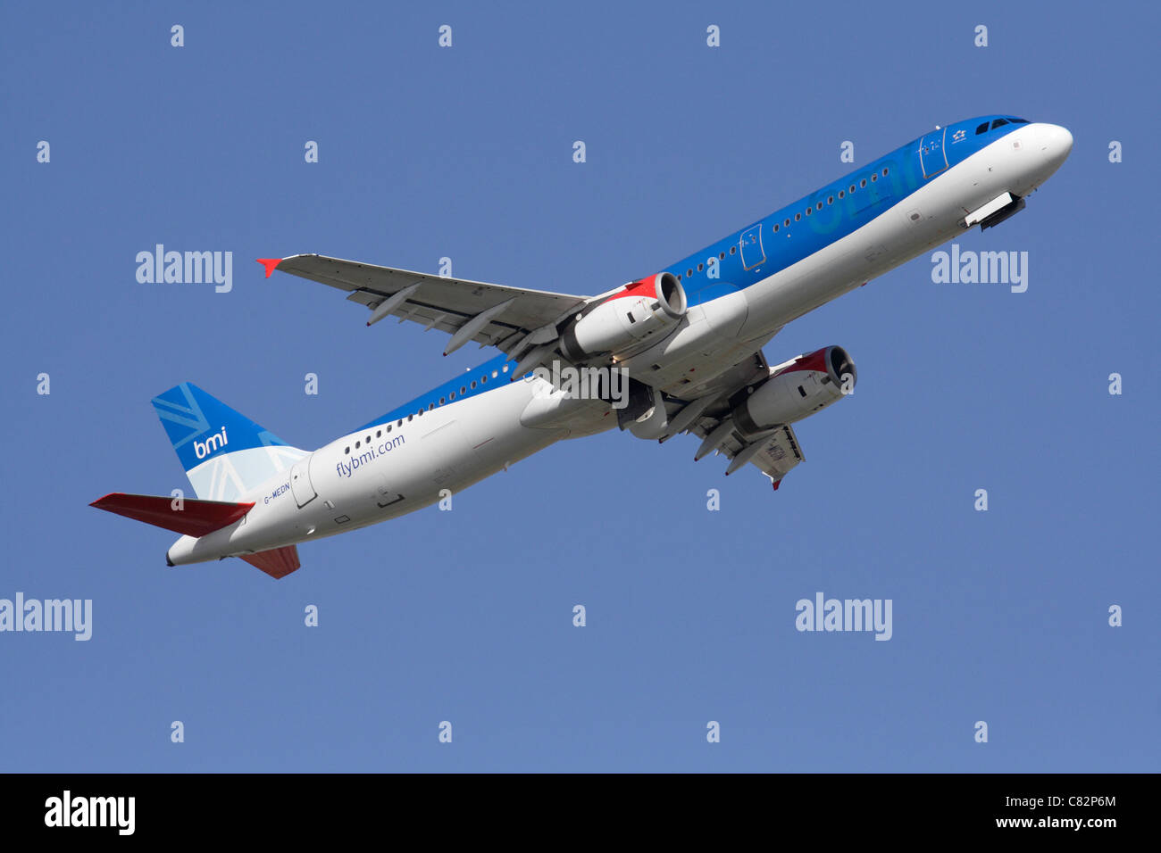 bmi Airbus A321 passenger jet plane in flight against a clear blue sky ...