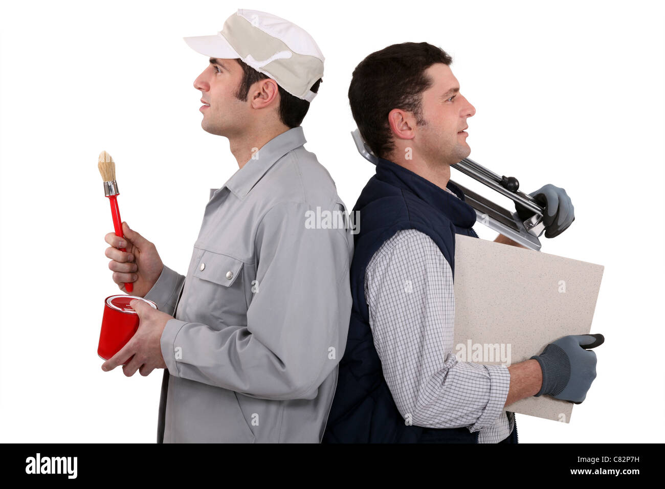 Two manual workers stood back to back Stock Photo - Alamy