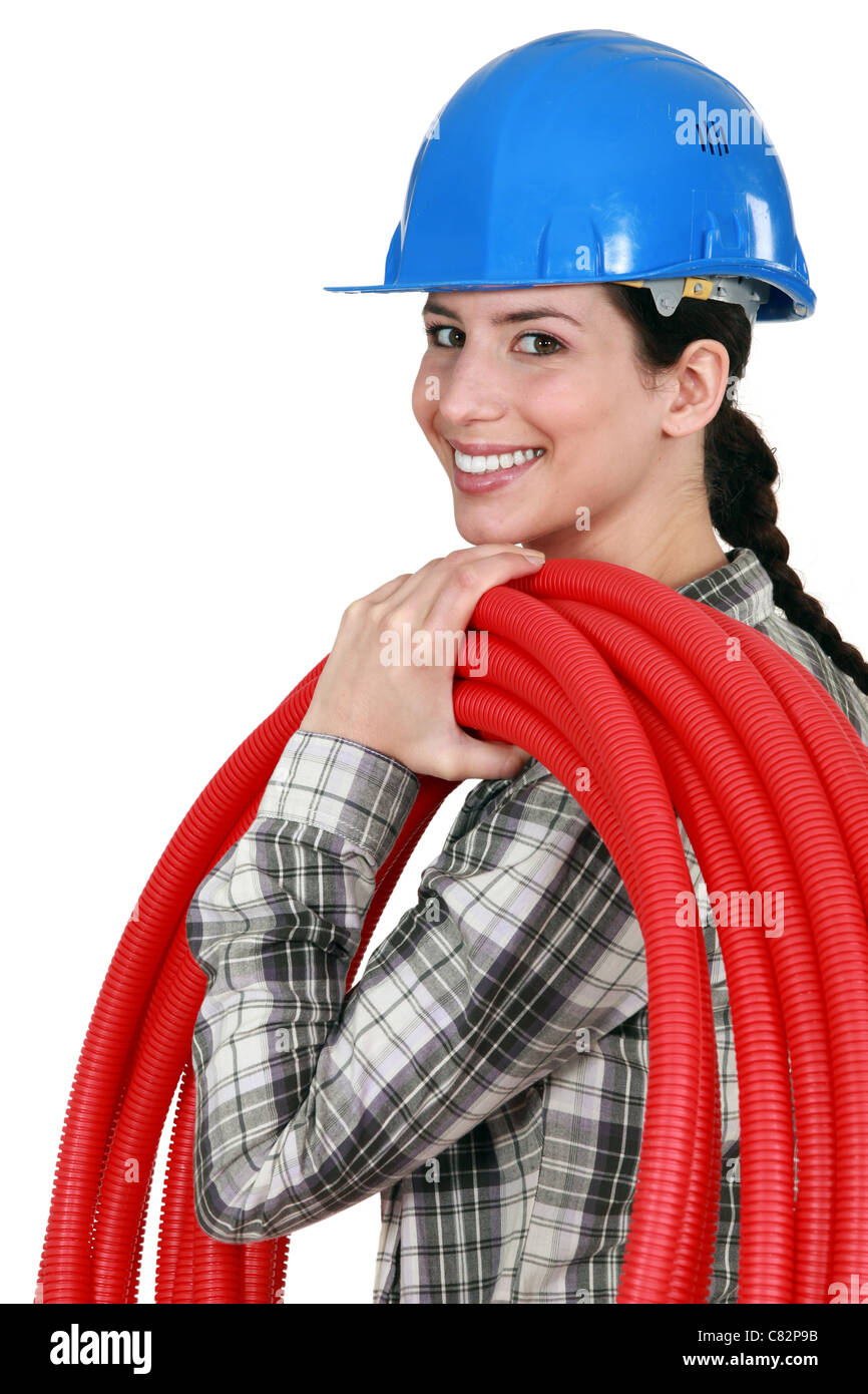 A woman carrying pipes Stock Photo - Alamy
