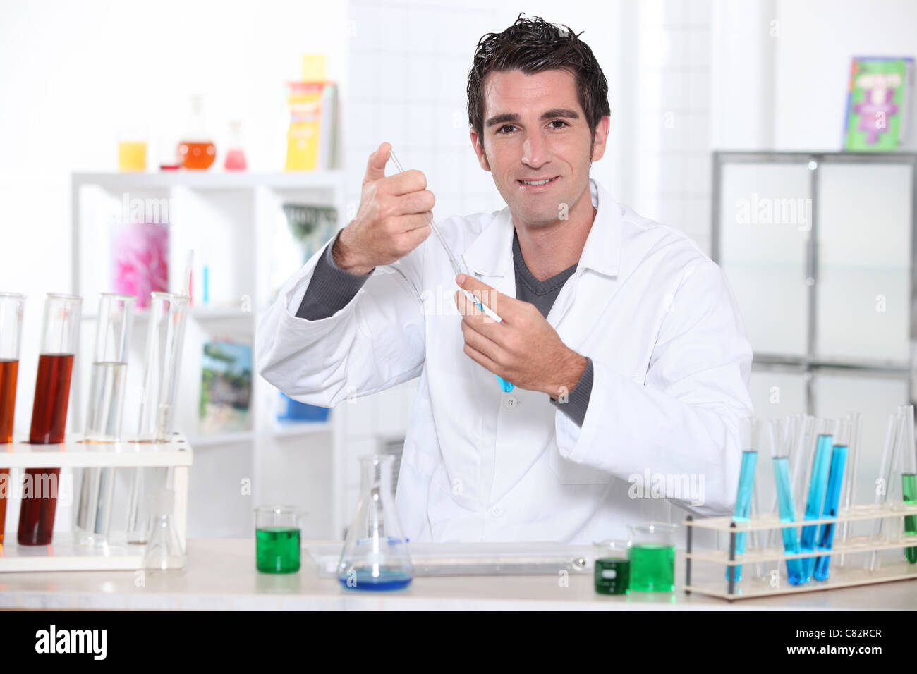 Student conducting experiment in laboratory Stock Photo - Alamy