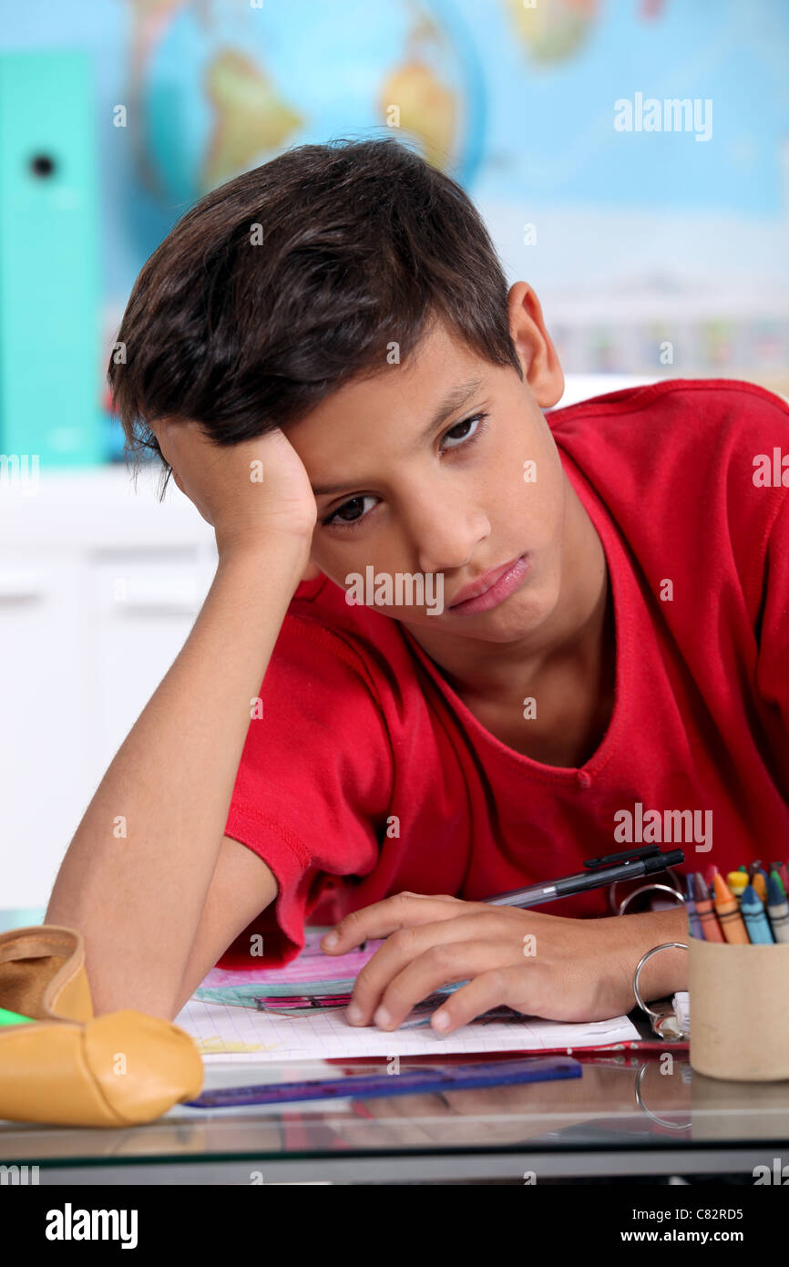 Bored little boy in classroom Stock Photo - Alamy