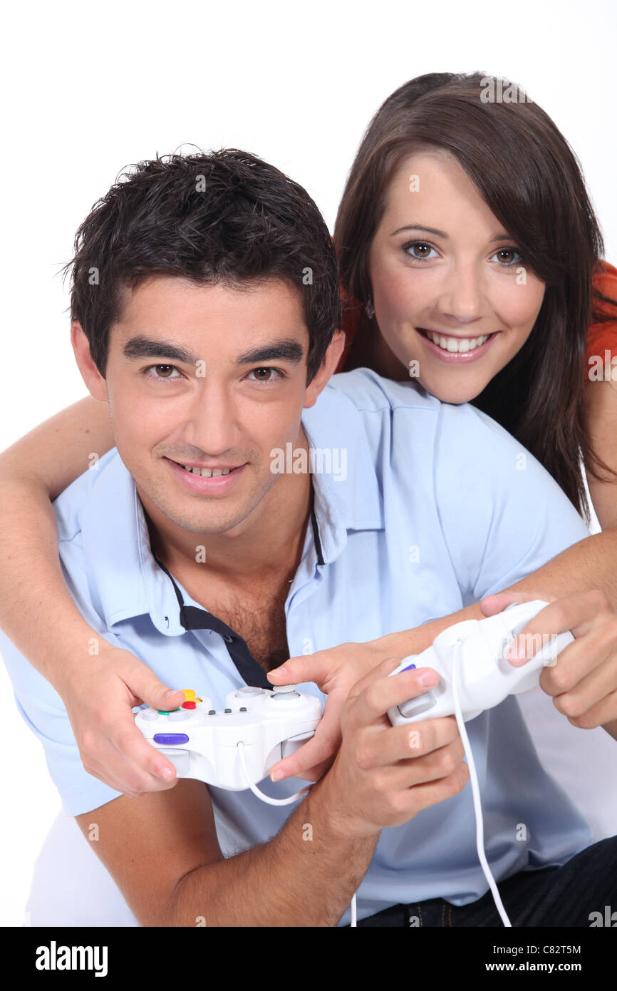 Young couple playing video games together Stock Photo - Alamy