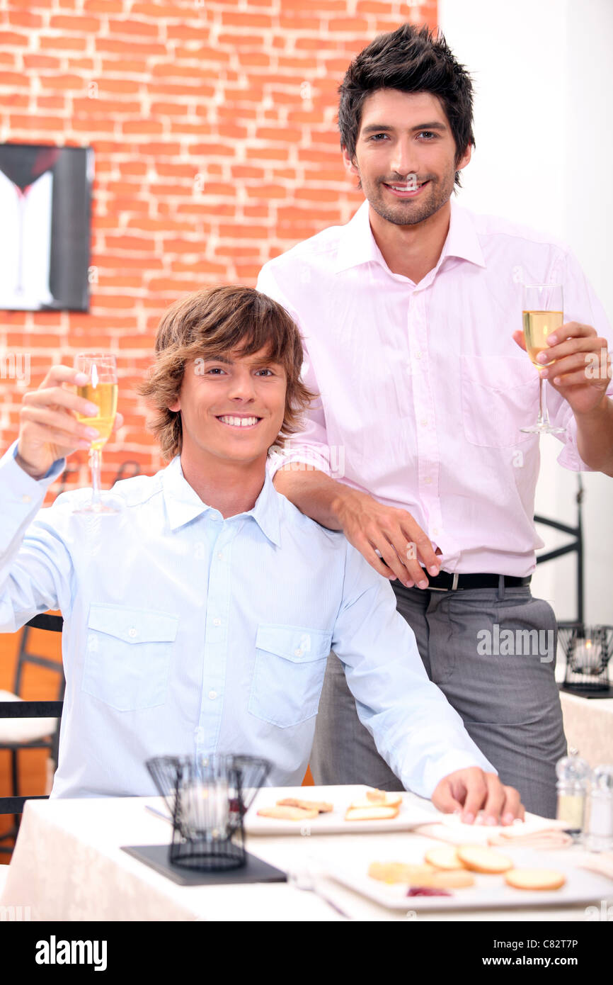 Men drinking champagne in a restaurant Stock Photo - Alamy