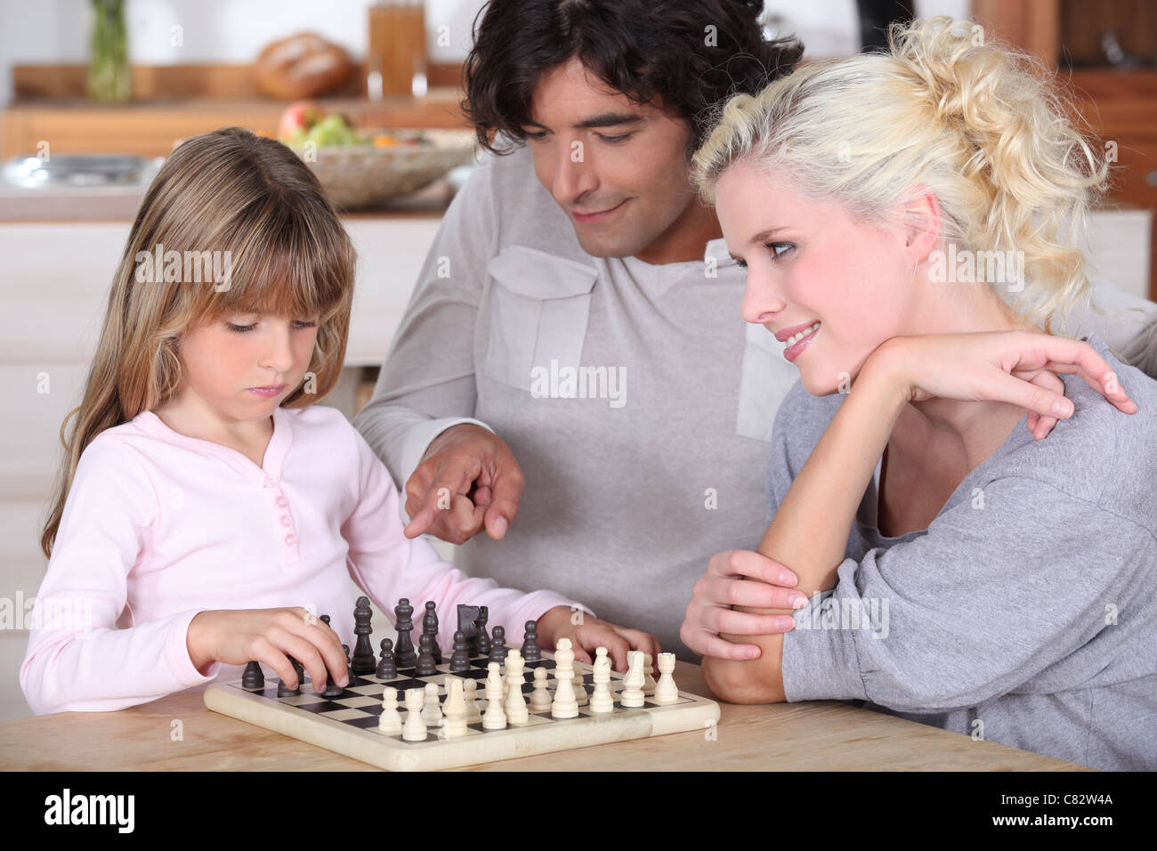 Family playing chess Stock Photo - Alamy