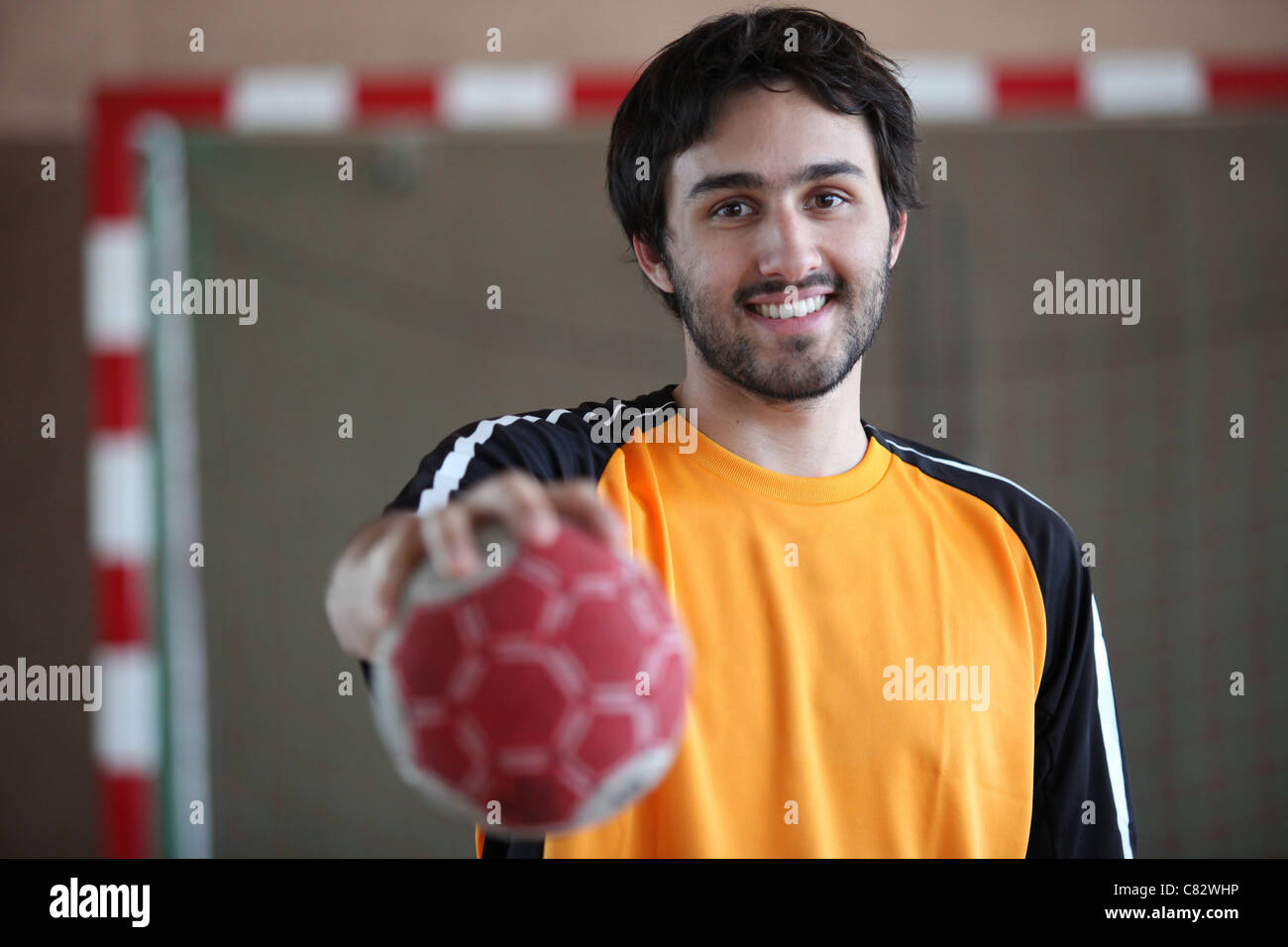 portrait of young handball player holding out ball Stock Photo - Alamy