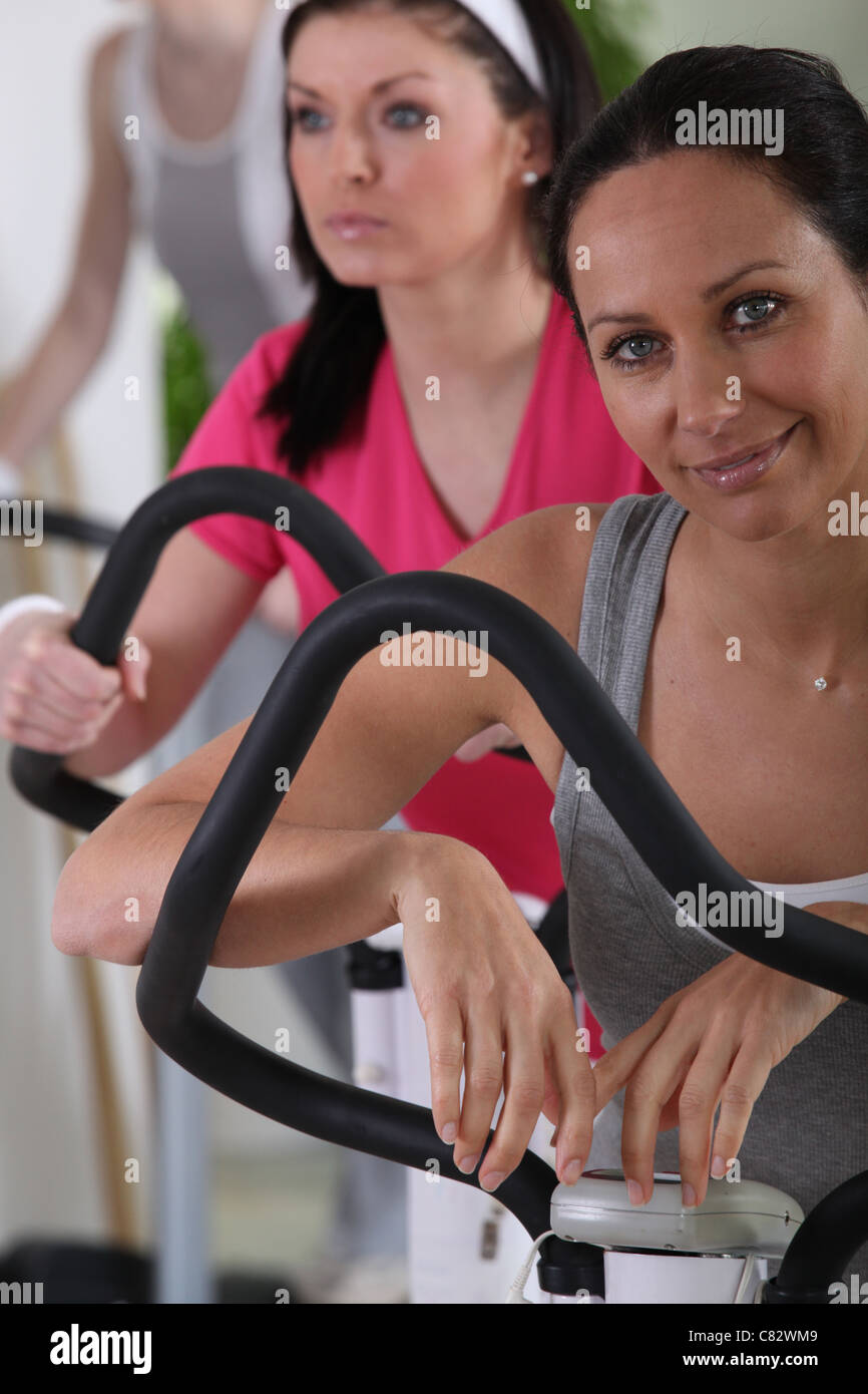Women using exercise equipment in a gym Stock Photo - Alamy