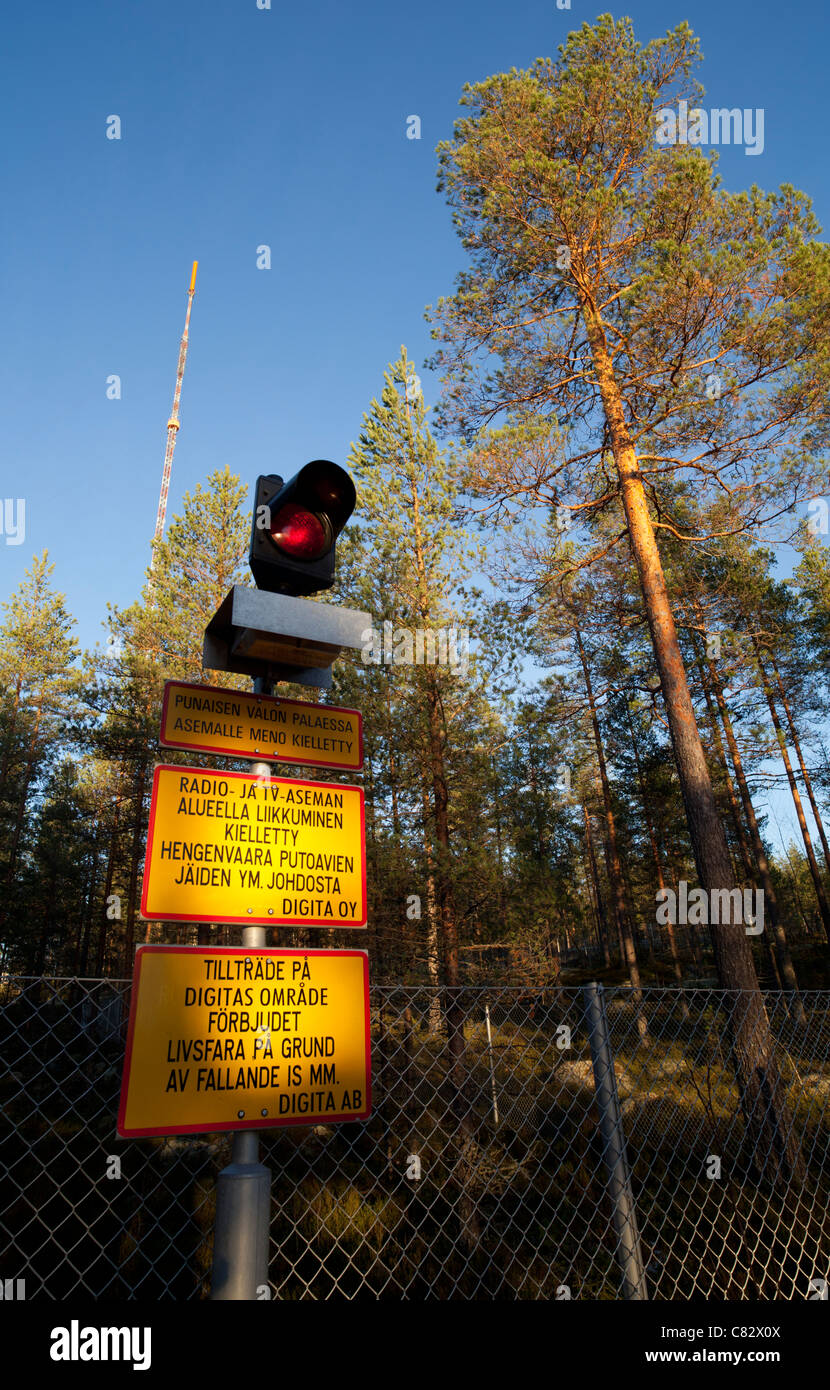 Multilingual sign ( Finnish , Swedish ) warning about trespassing and ...