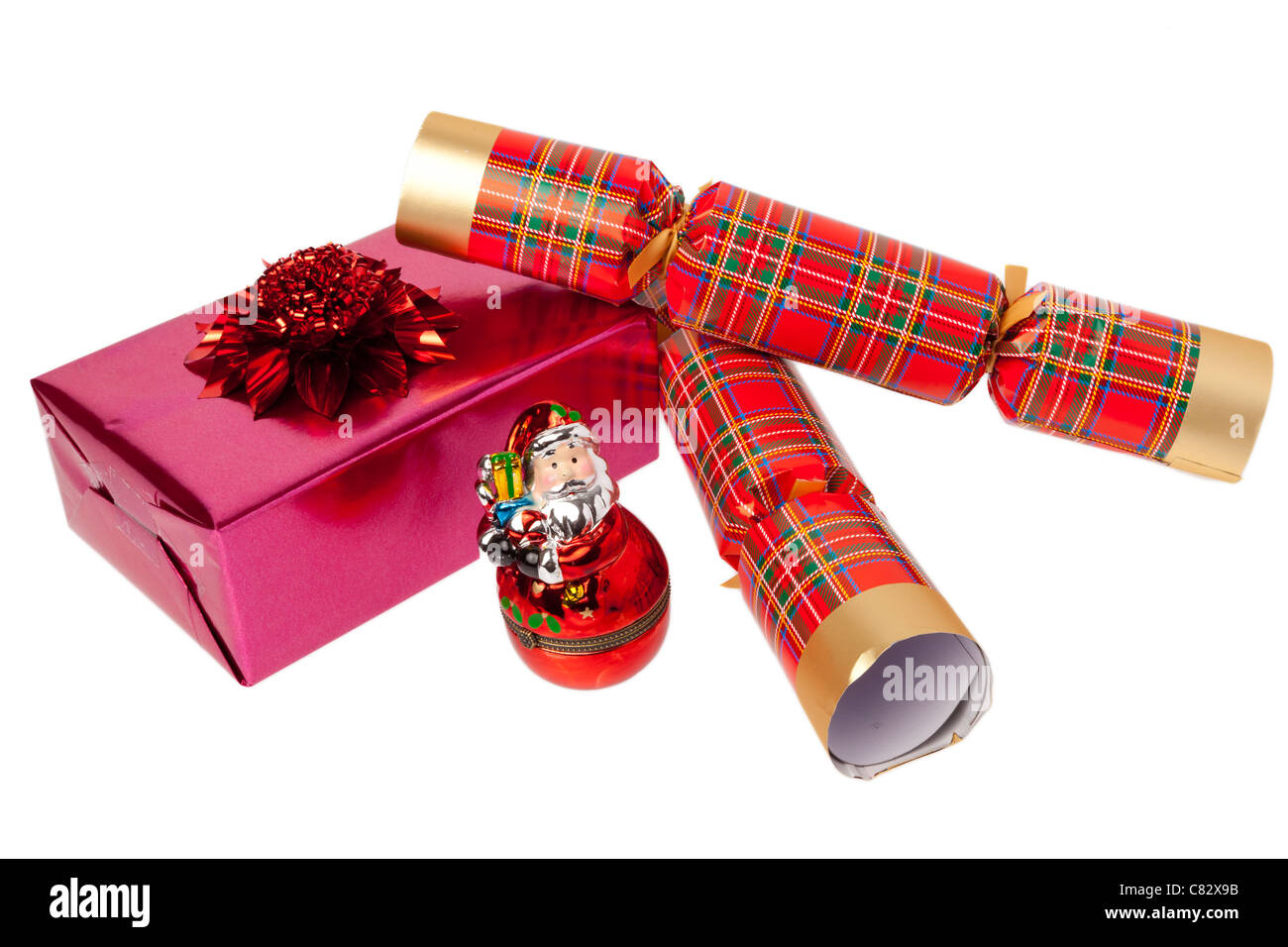 Two chrismas crackers with a present on a white isolated background ...