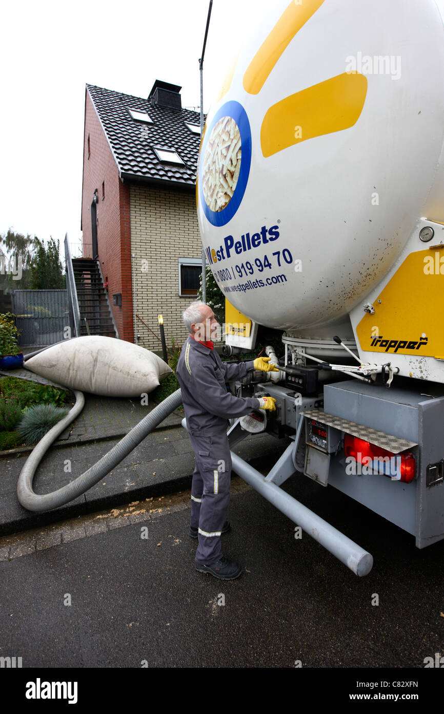 Delivery of wood pellets from a tanker truck to a private home. The ...