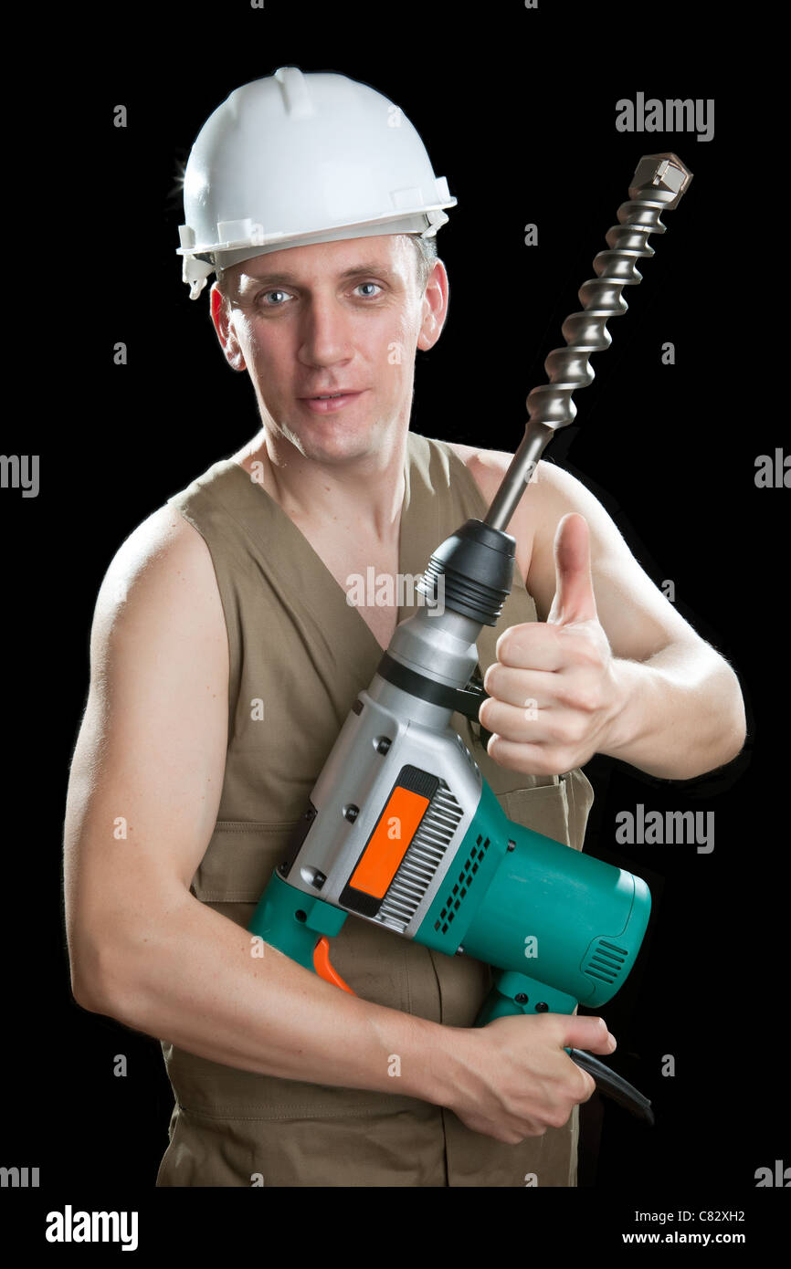 The builder in a protective helmet holds the hammer Stock Photo - Alamy