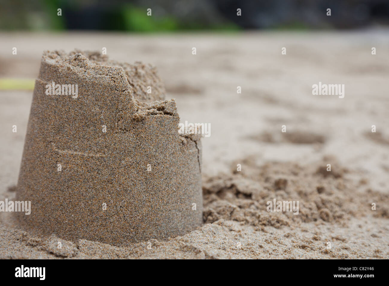 Broken sandcastle on a sandy beach Stock Photo - Alamy