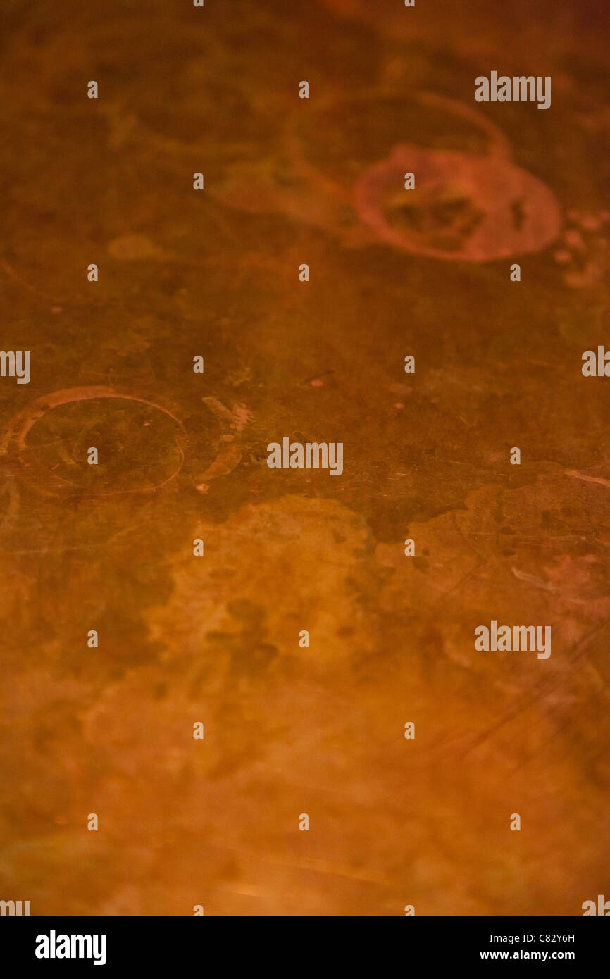 Brass bar surface showing stained rings where drinks have been placed ...
