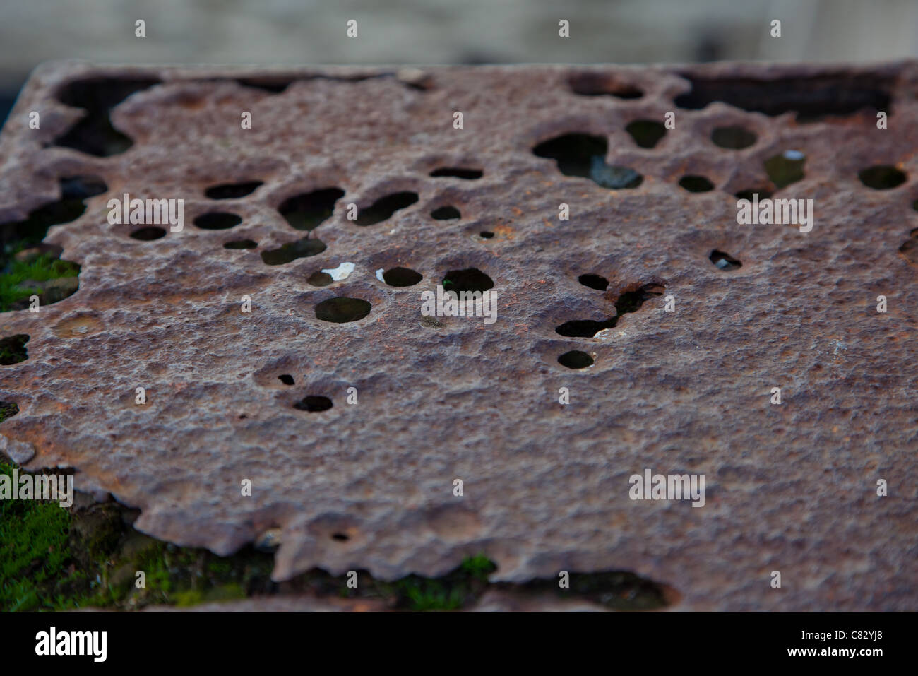 A rusty, damaged cap to a mooring post located on a beach Stock Photo ...