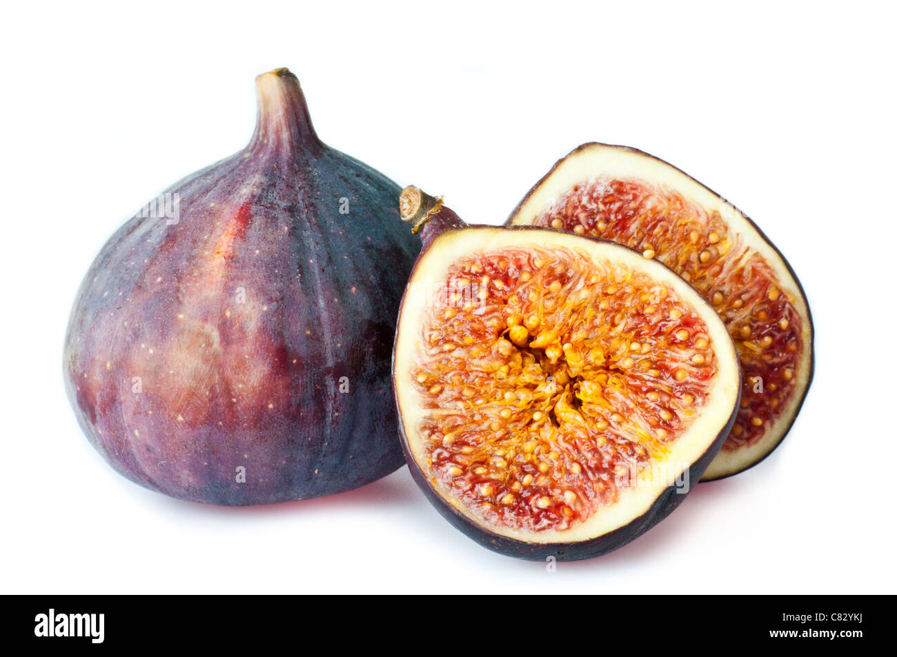 Two Figs with one Cut in Half on a White Background Stock Photo - Alamy