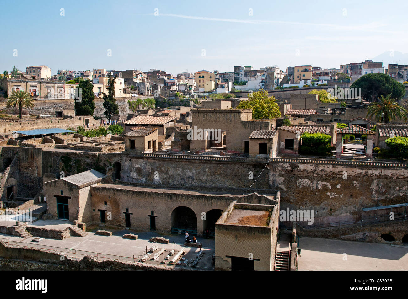 The excavated site of Herculaneum in the foreground with the town of ...