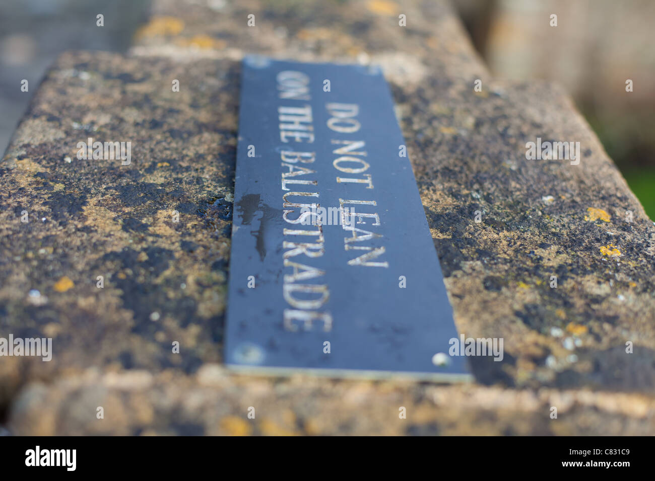 Sign saying Do not lean on the balustrade Stock Photo - Alamy