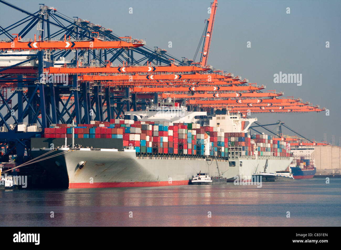 Harbor cranes loading container ships in the port of Rotterdam Stock ...