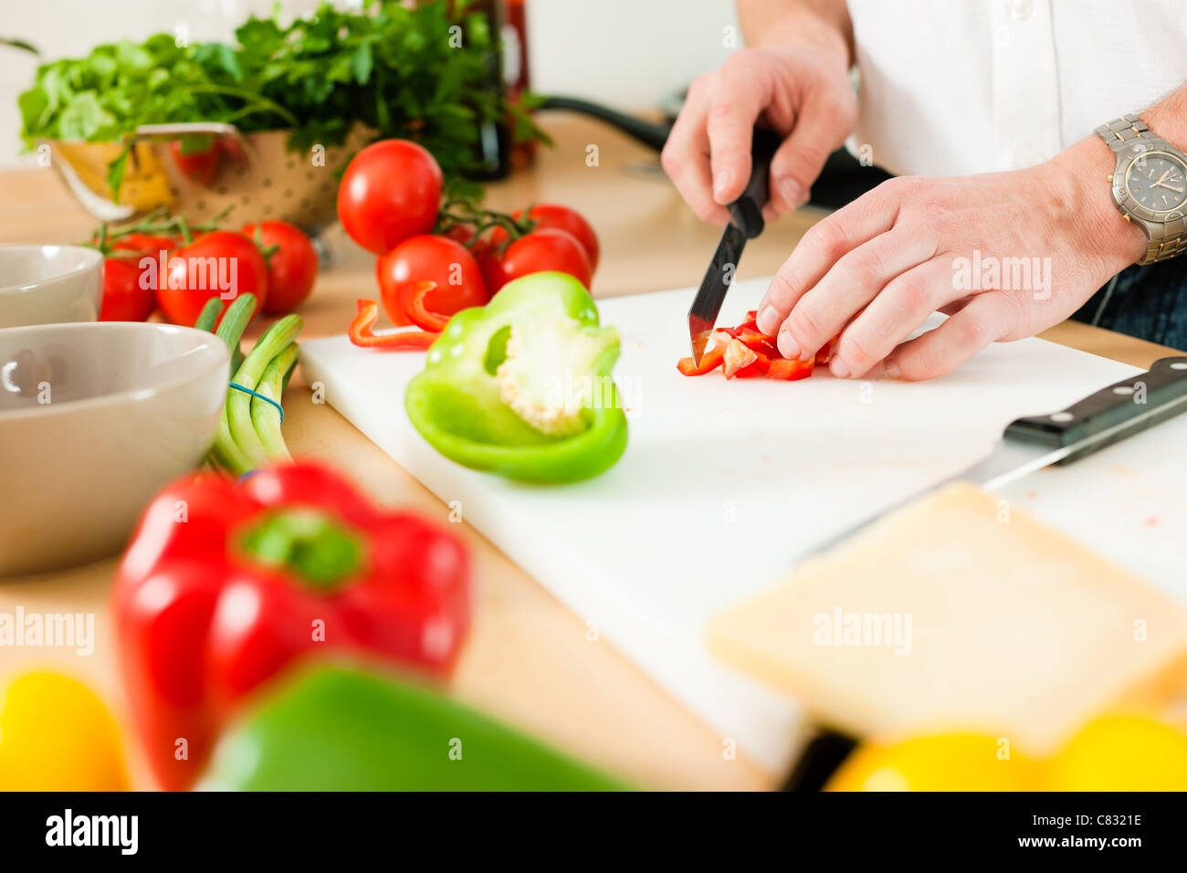 Man in the kitchen – only hands to be seen – is preparing the ...