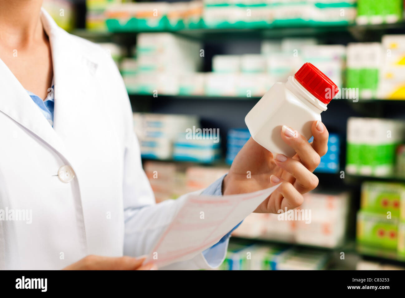 Female pharmacist -only hands to be seen -standing in pharmacy with ...