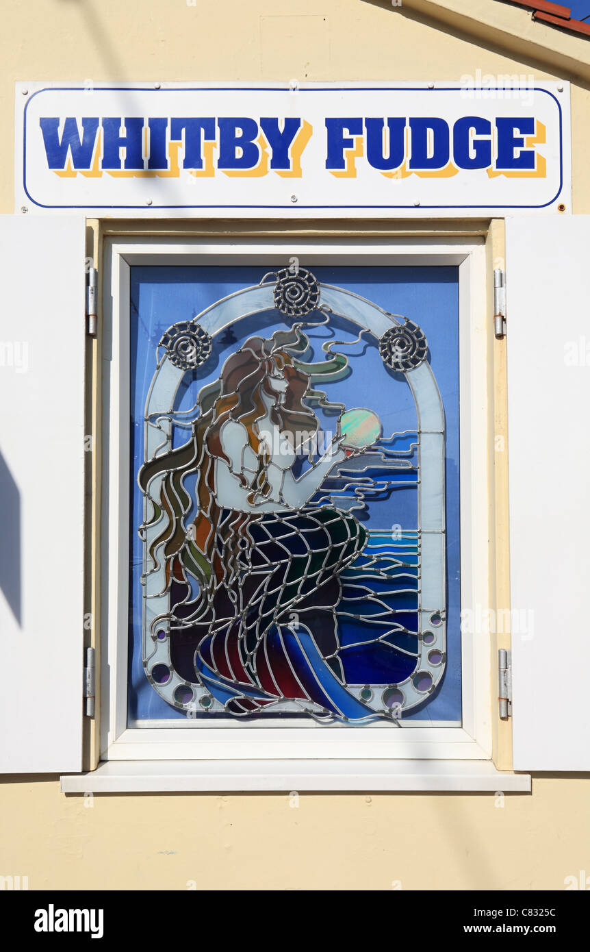 A stained glass window advertising Whitby fudge Stock Photo - Alamy