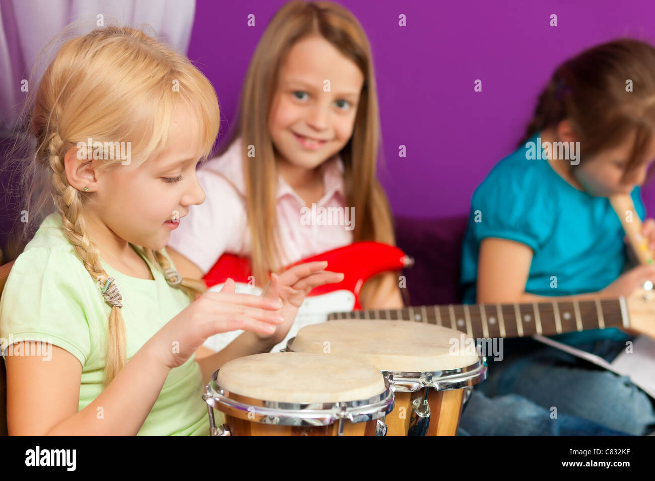 Child playing bongo drums hi-res stock photography and images - Alamy