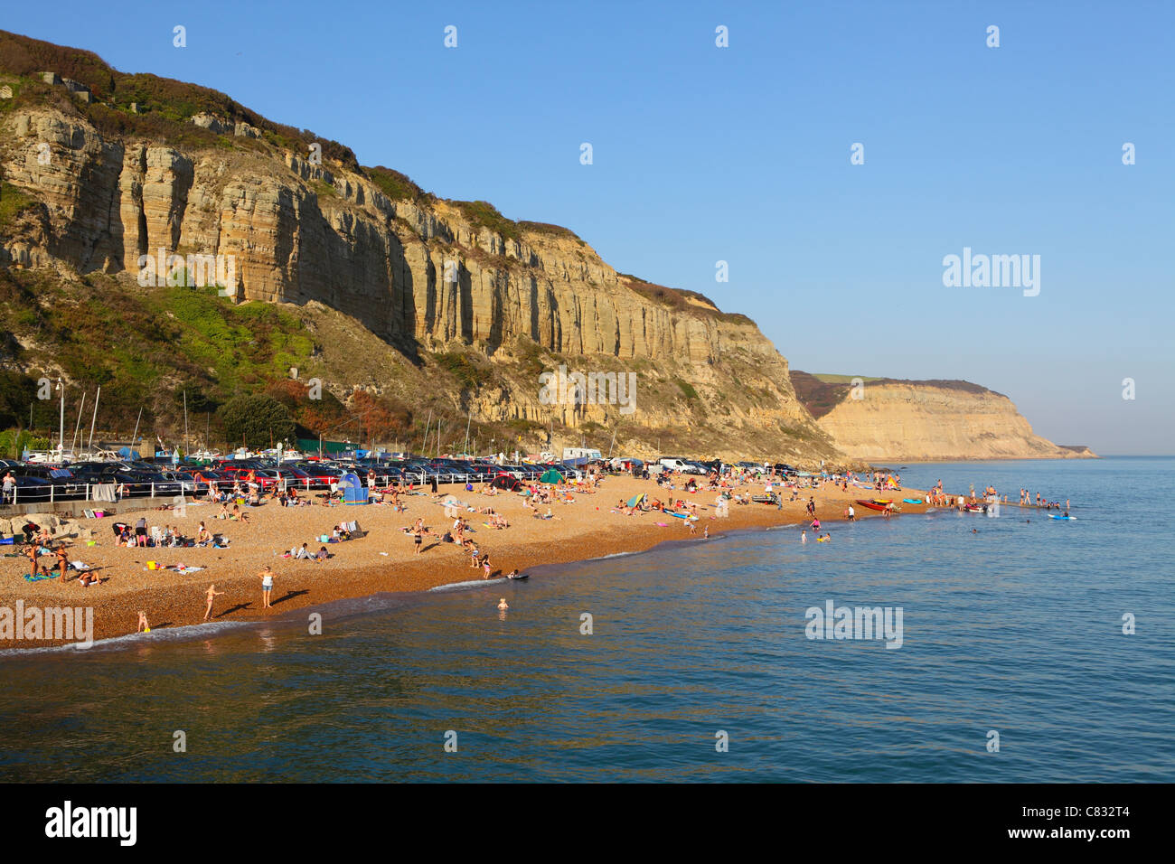 People sunbathing in October, on the beach below Rock-a-Nore Cliffs, at ...