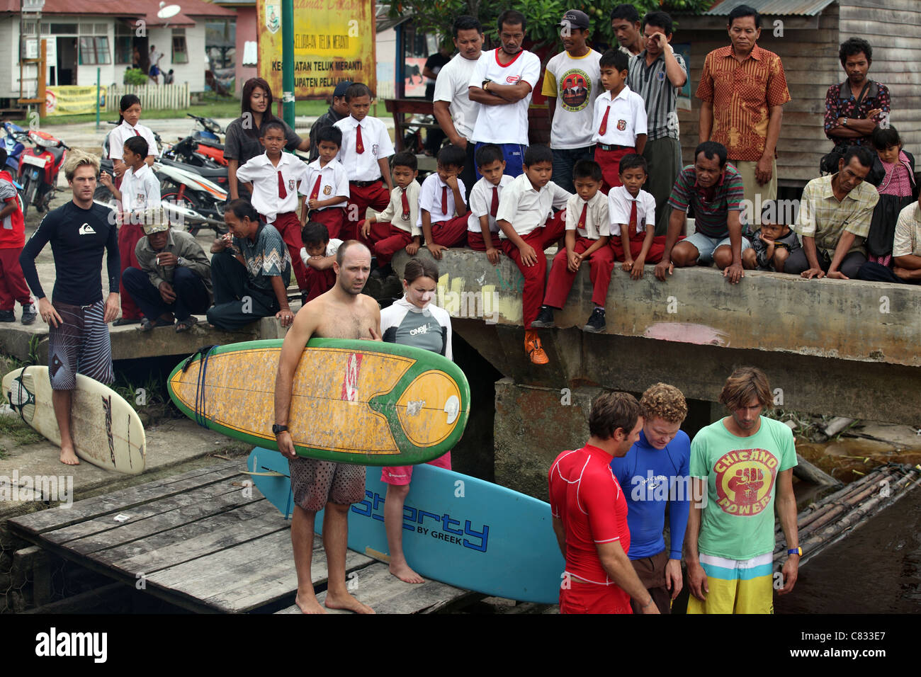 Visiting surfers prepare for a days tidal bore surfing on the Kampar ...