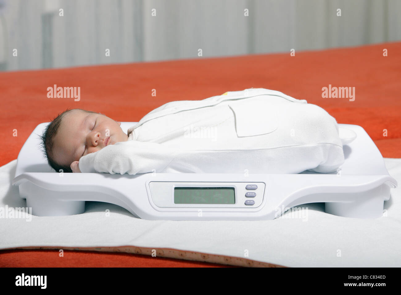 baby boy on weight scale Stock Photo - Alamy