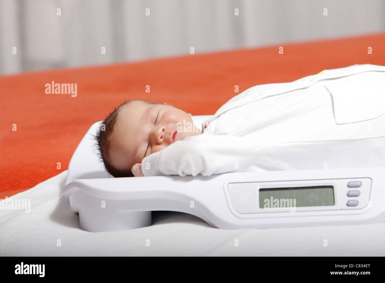Baby boy on weight scale hi-res stock photography and images - Alamy