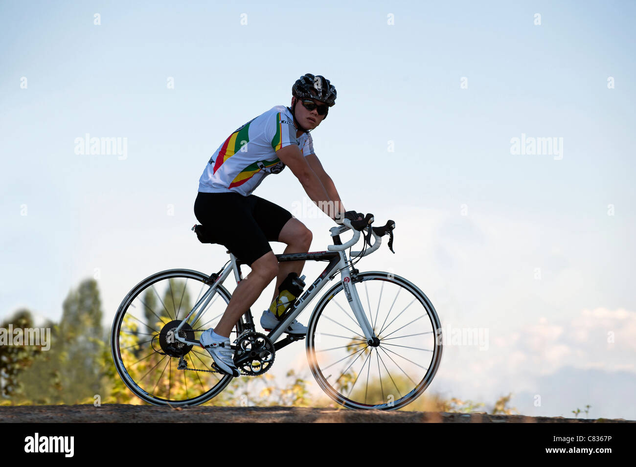 A man biking on the road Stock Photo - Alamy
