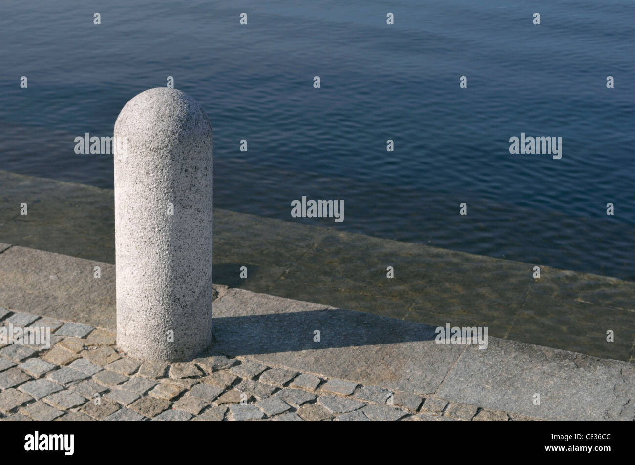 stone bollard on lakeshore Stock Photo - Alamy