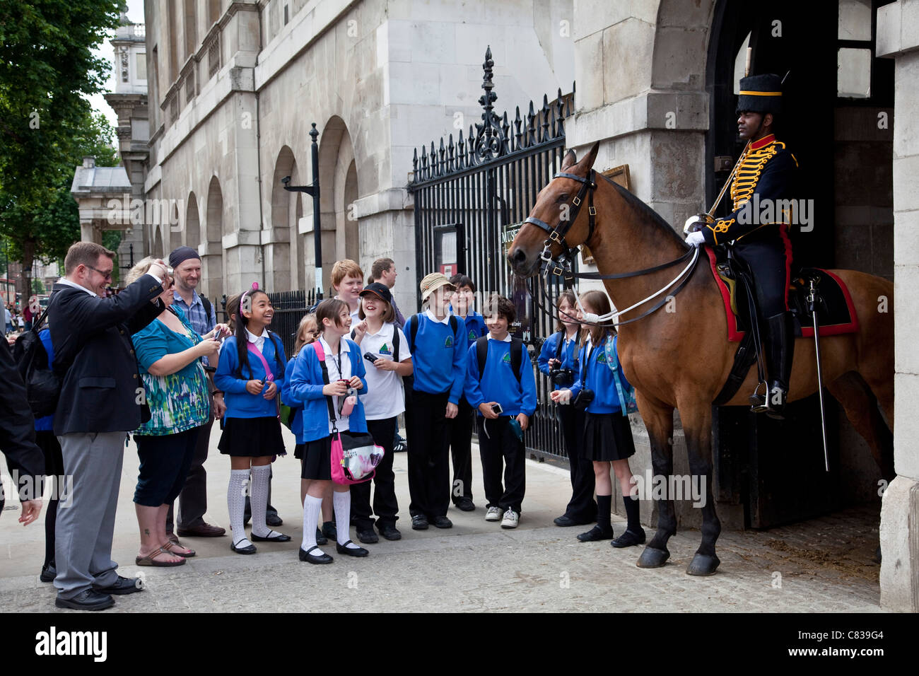 British Schoolchildren pose for photographs with a soldier from the ...